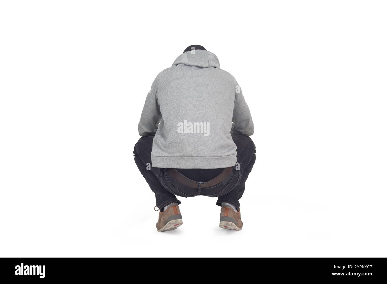 back view of man squatting and looking down on white background Stock ...