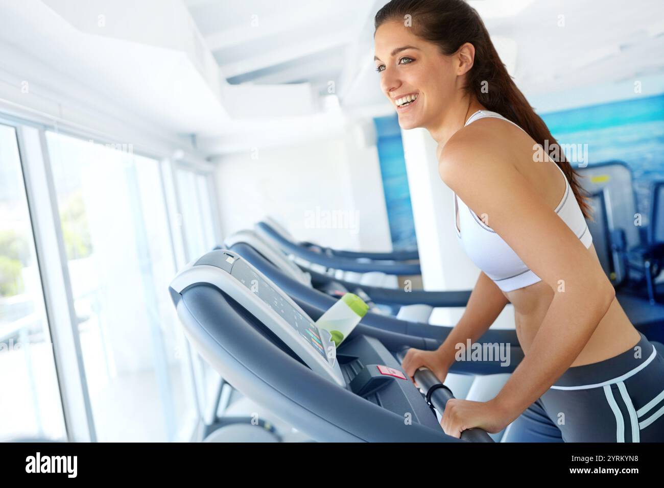 Woman, workout and running with treadmill for marathon, exercise or ...
