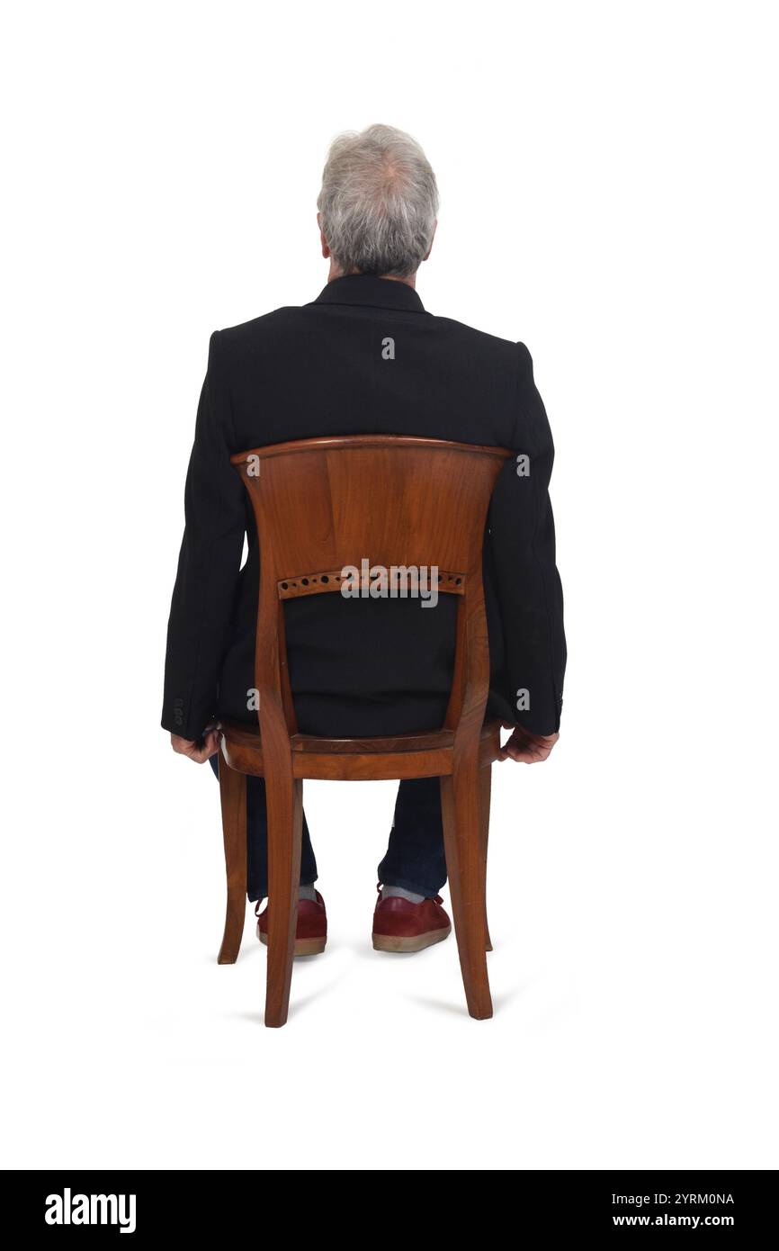 back view of middle aged man sitting on chair on white background Stock ...