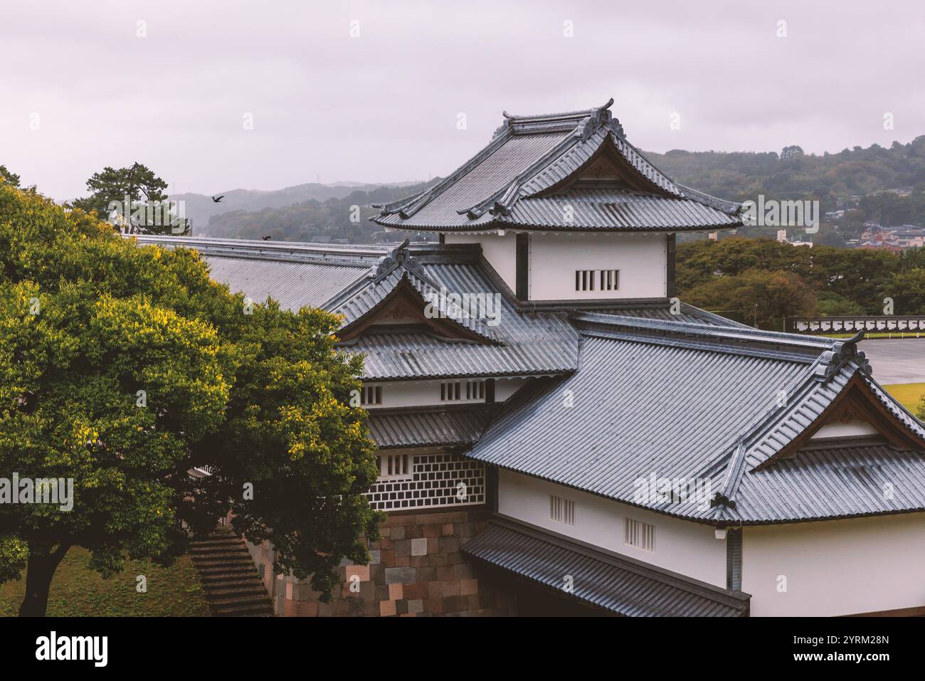 Traditional Japanese castle that is surrounded by lush greenery and ...