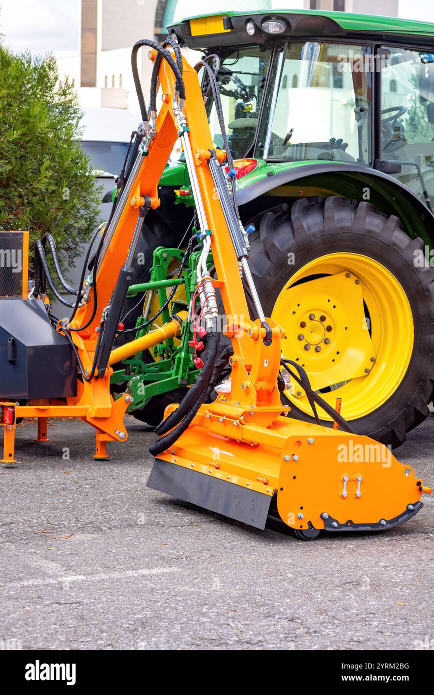 Heavy machinery in action at a rural maintenance site during a sunny ...