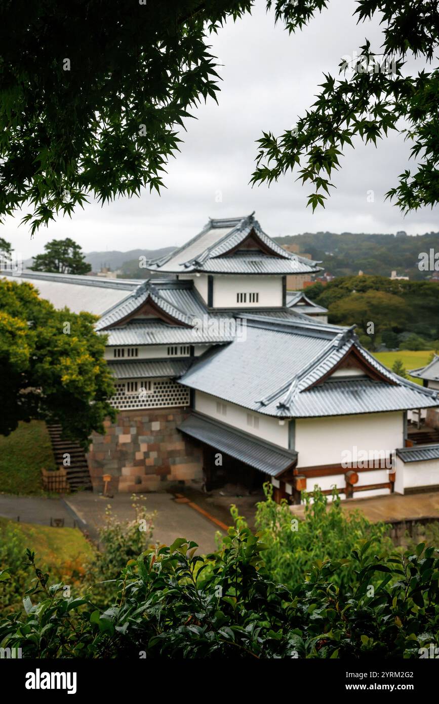 Traditional Japanese castle that is surrounded by lush greenery and ...