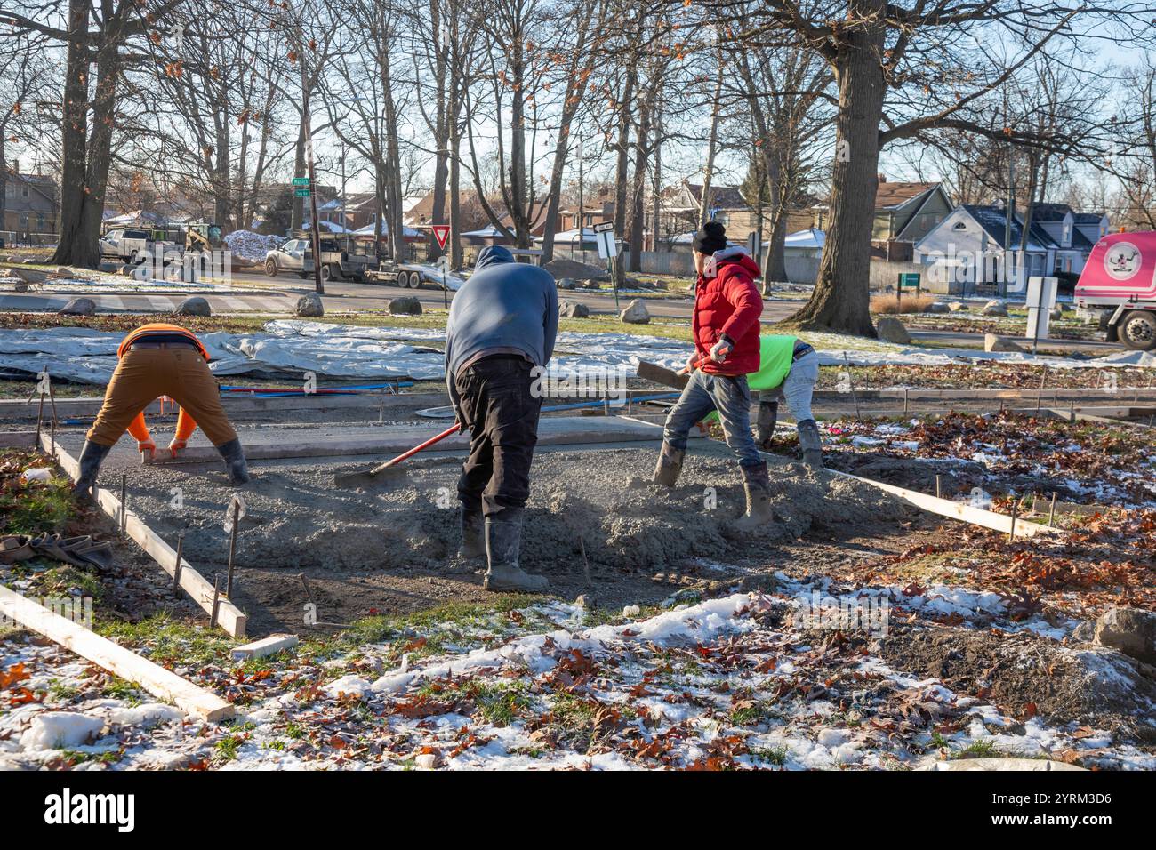 Detroit, Michigan - Workers pour and finish concrete for walking paths ...