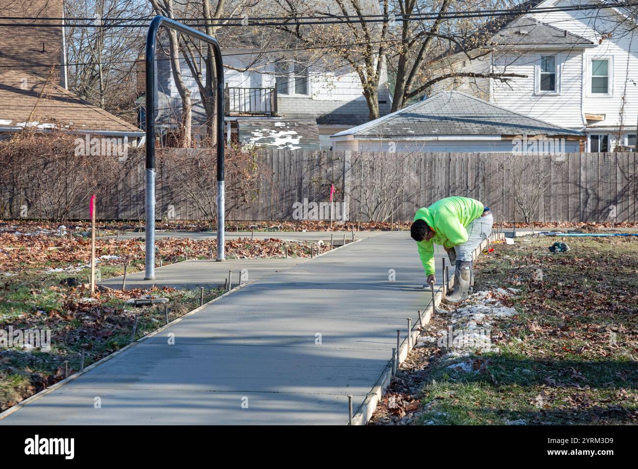 Detroit, Michigan - Workers pour and finish concrete for walking paths ...