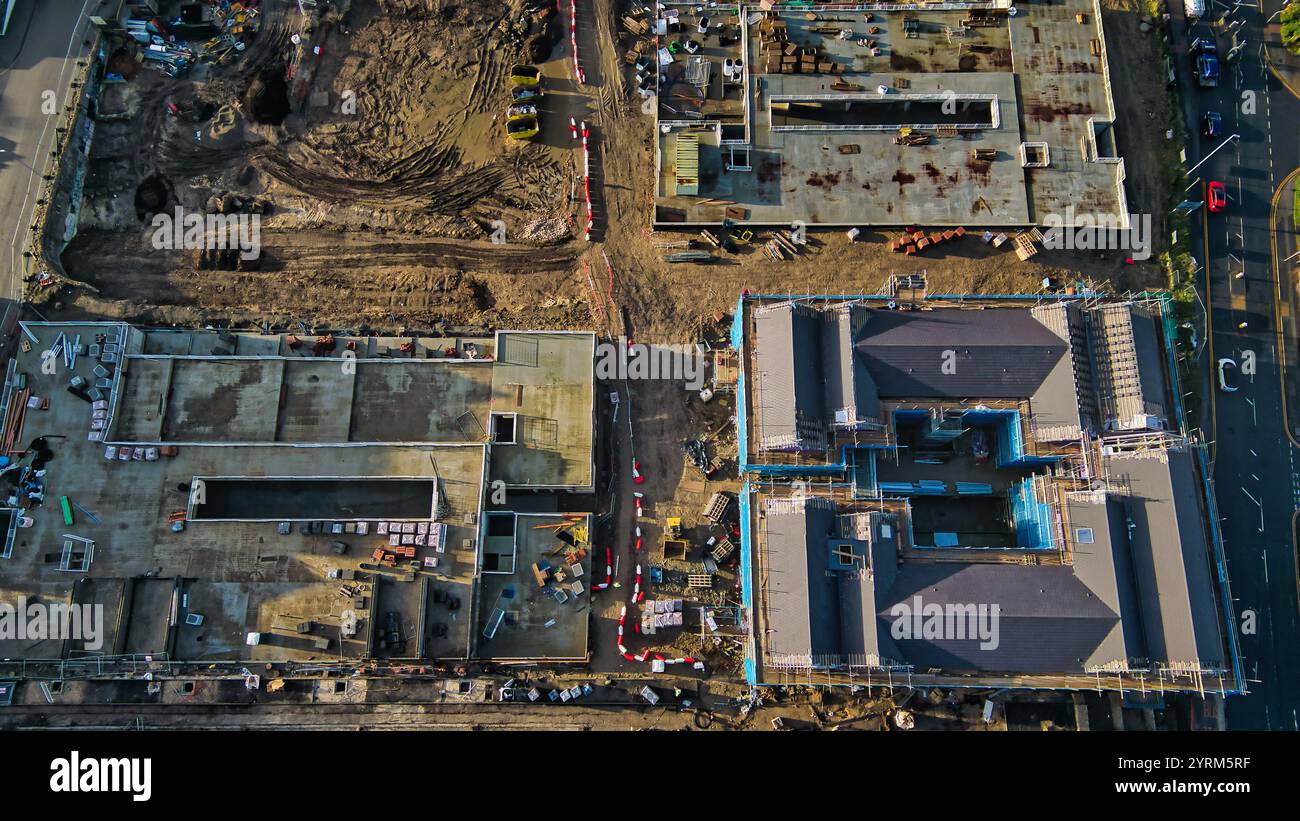 Aerial view of a construction site showing two phases: unfinished ...