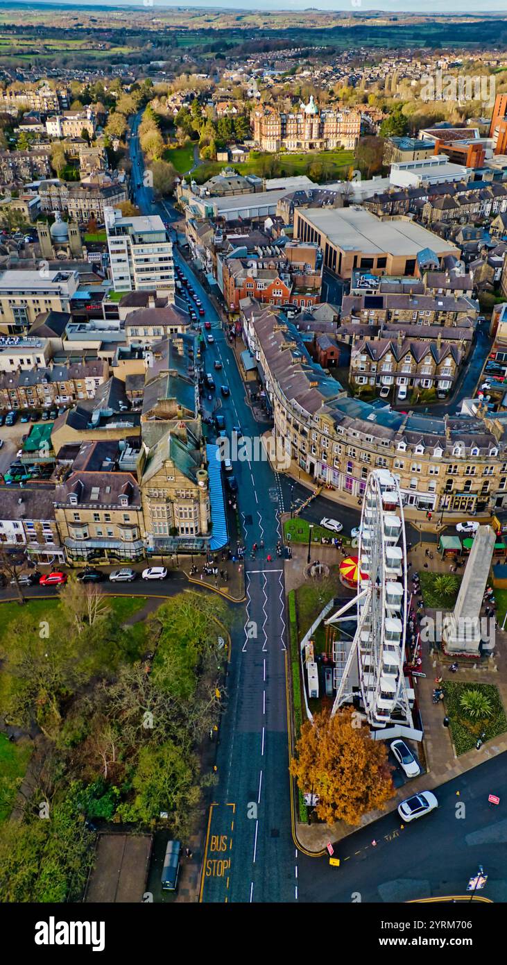 Aerial view of a town center with buildings, streets, a Ferris wheel ...