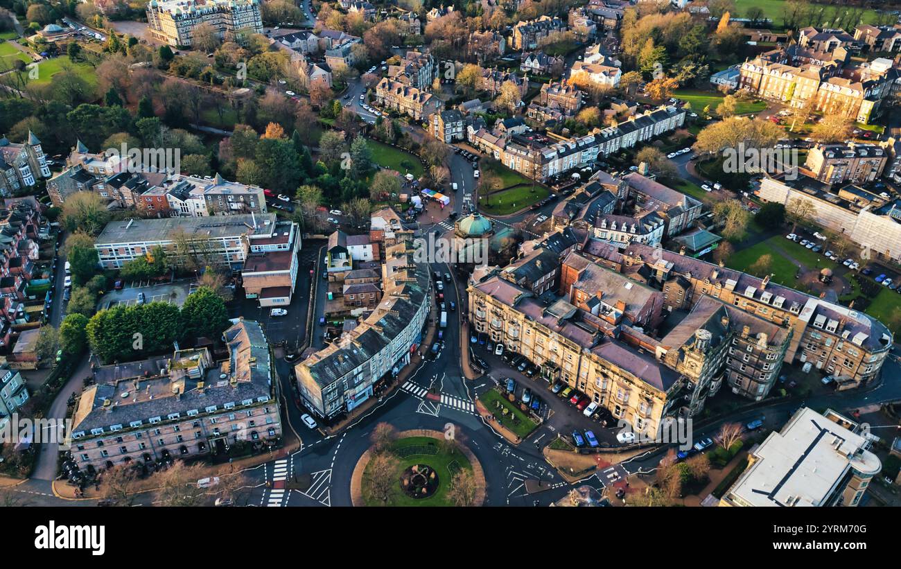 Aerial view of a town center, featuring a complex road intersection ...