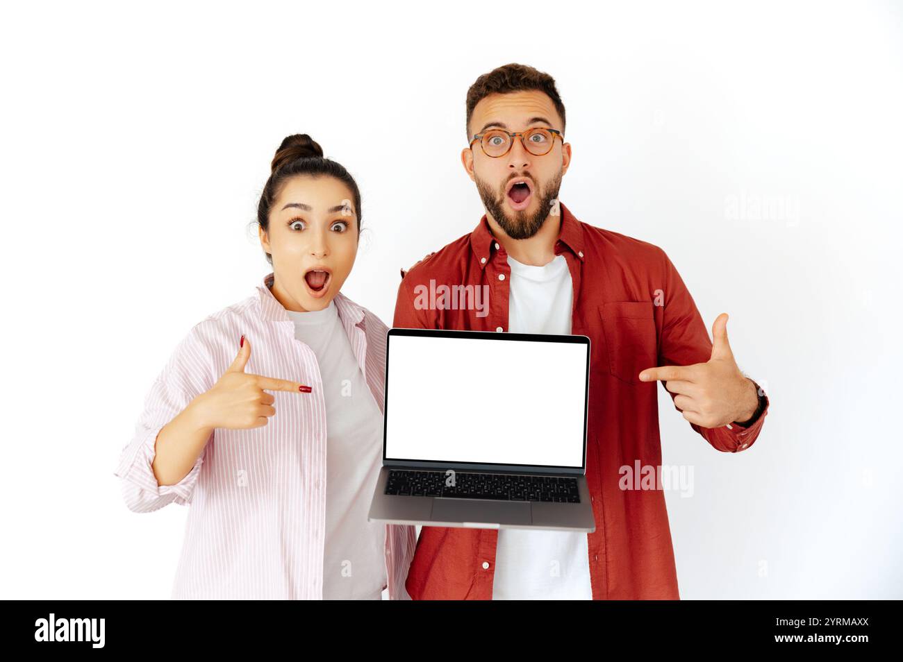 Surprised man and woman of arabian or caucasian ethnicity, holding ...