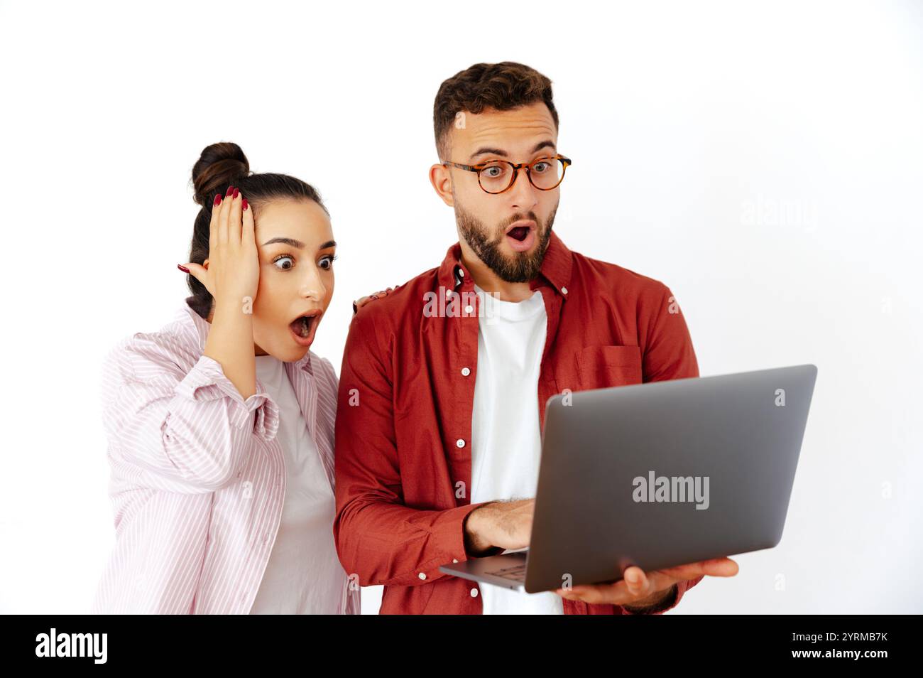 Excited man and woman, arabian or caucasian ethnicity, both staring at ...