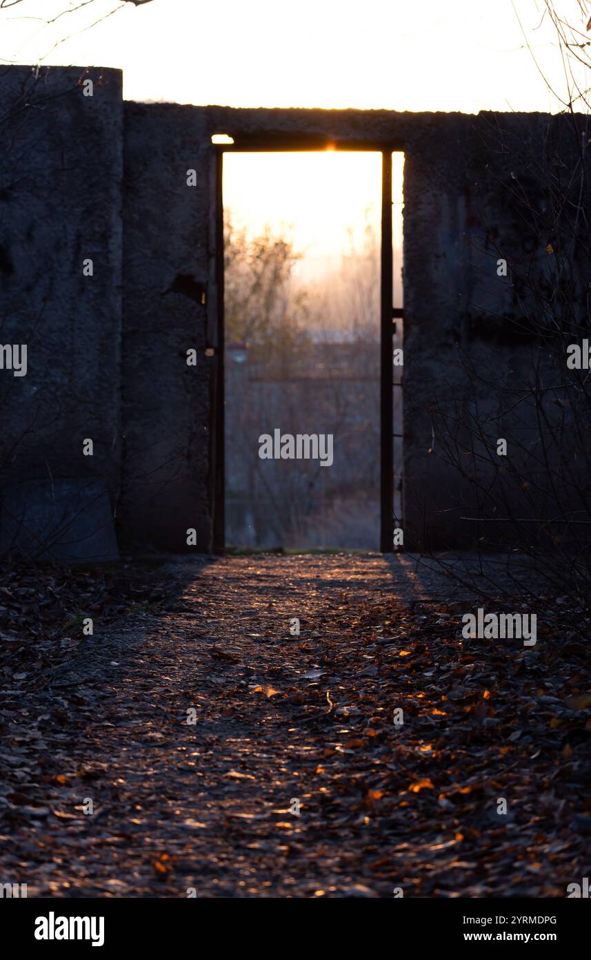 The sunset rays of the sun pass through the open doorway in the ...