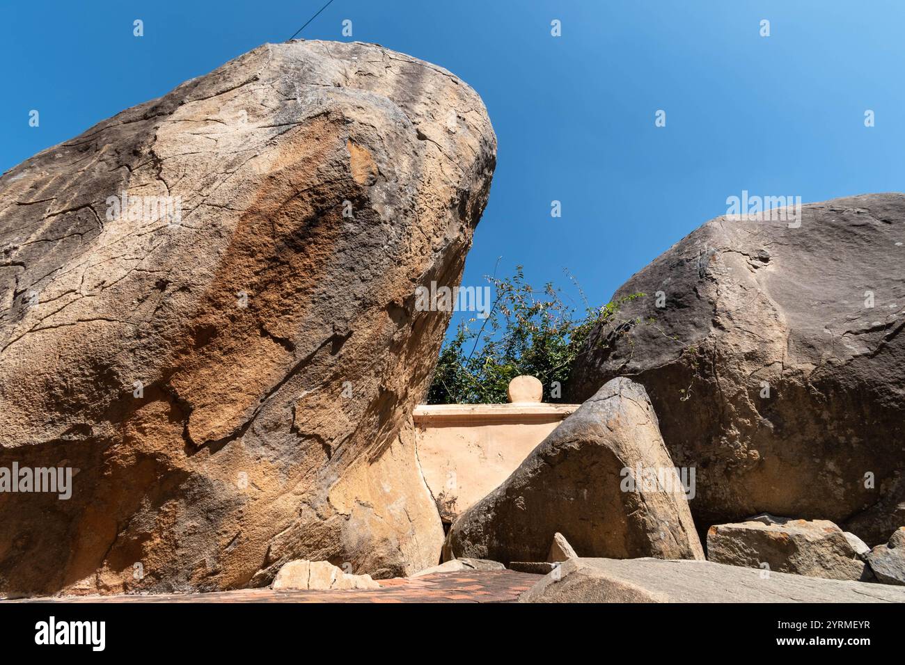Giant boulders and blue skies tower over the stairs at Shravanabelagola ...