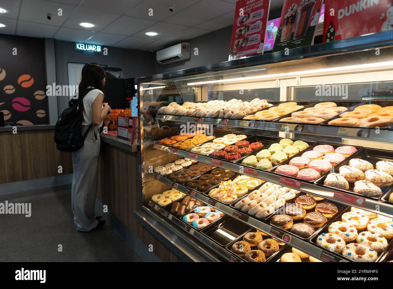 KUALA LUMPUR, MALAYSIA - NOVEMBER 28, 2023: donuts displayed in a glass ...