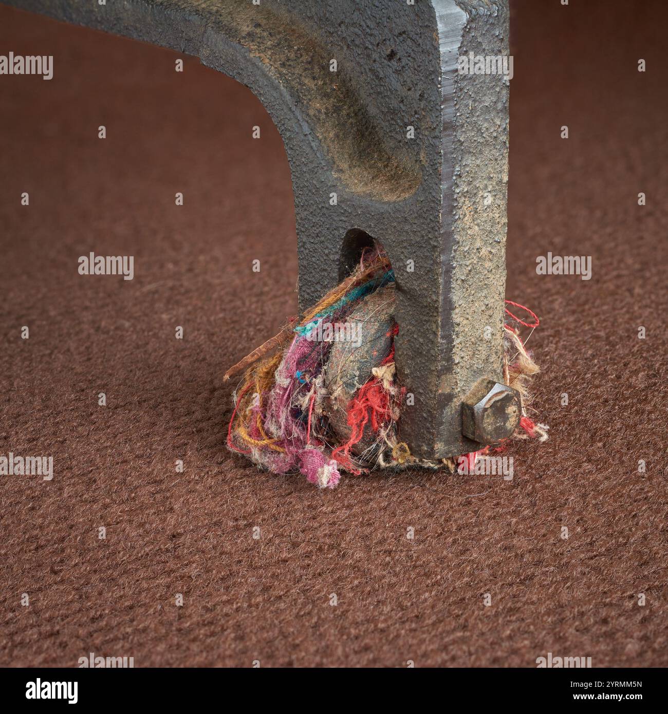 close-up of metal wheel tangled mess of colorful threads that got ...