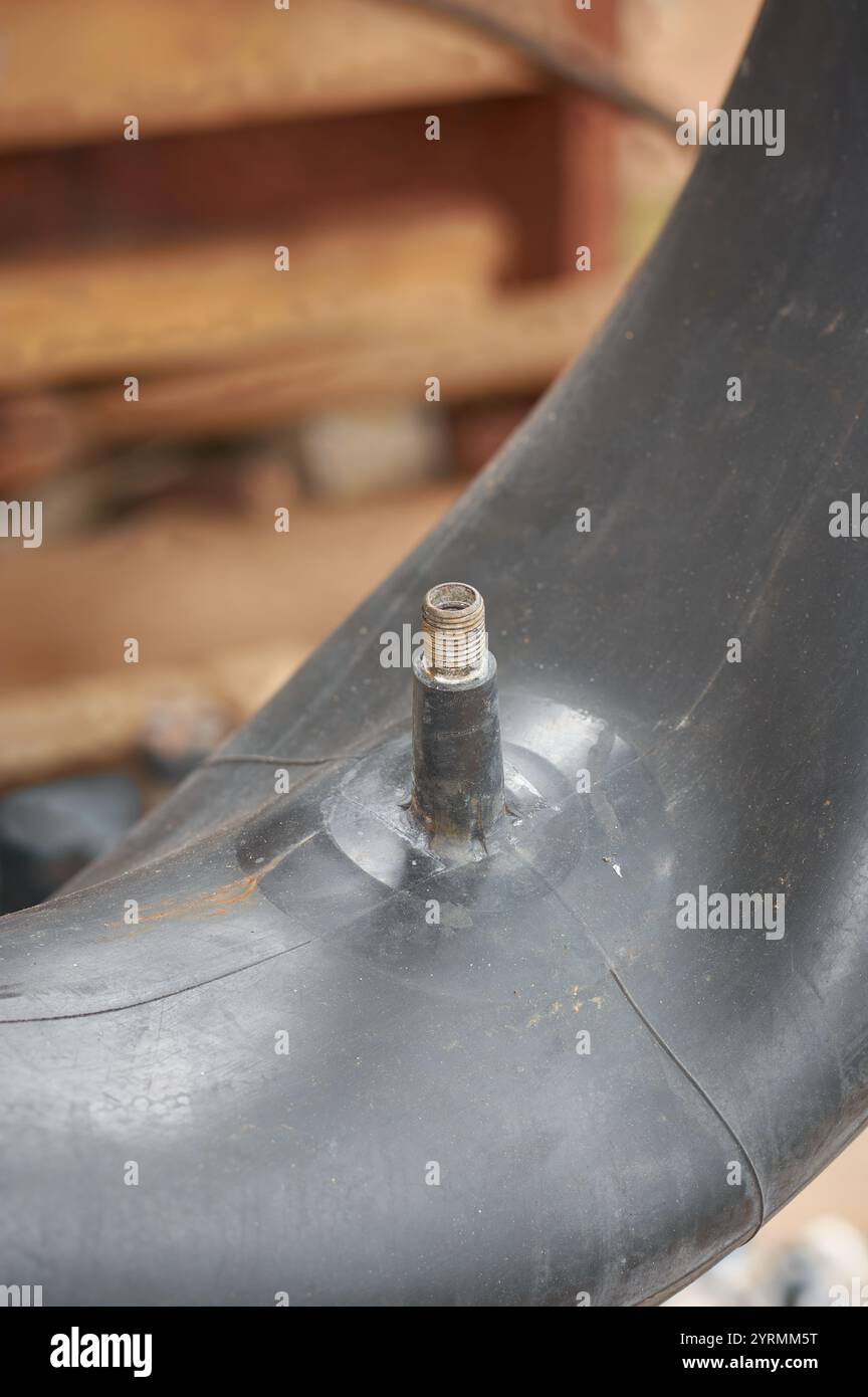 old dirty inner tube valve stem of a car tire, rust or grime in the ...