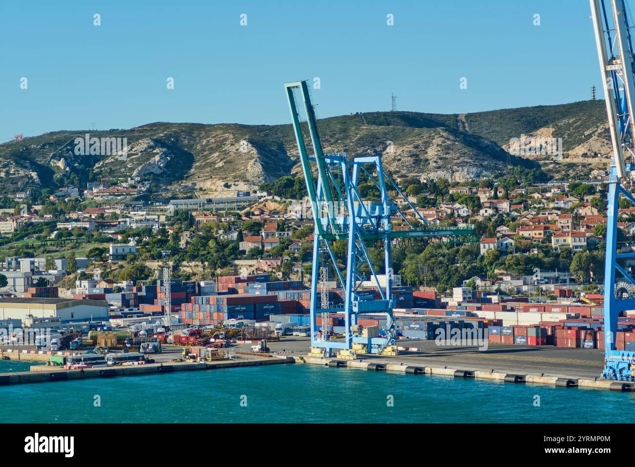 The image captures a towering crane at the Marseille port, with ...