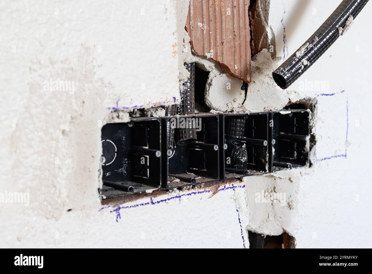 Corrugated pipe and electrical boxes being installed in a wall during a ...