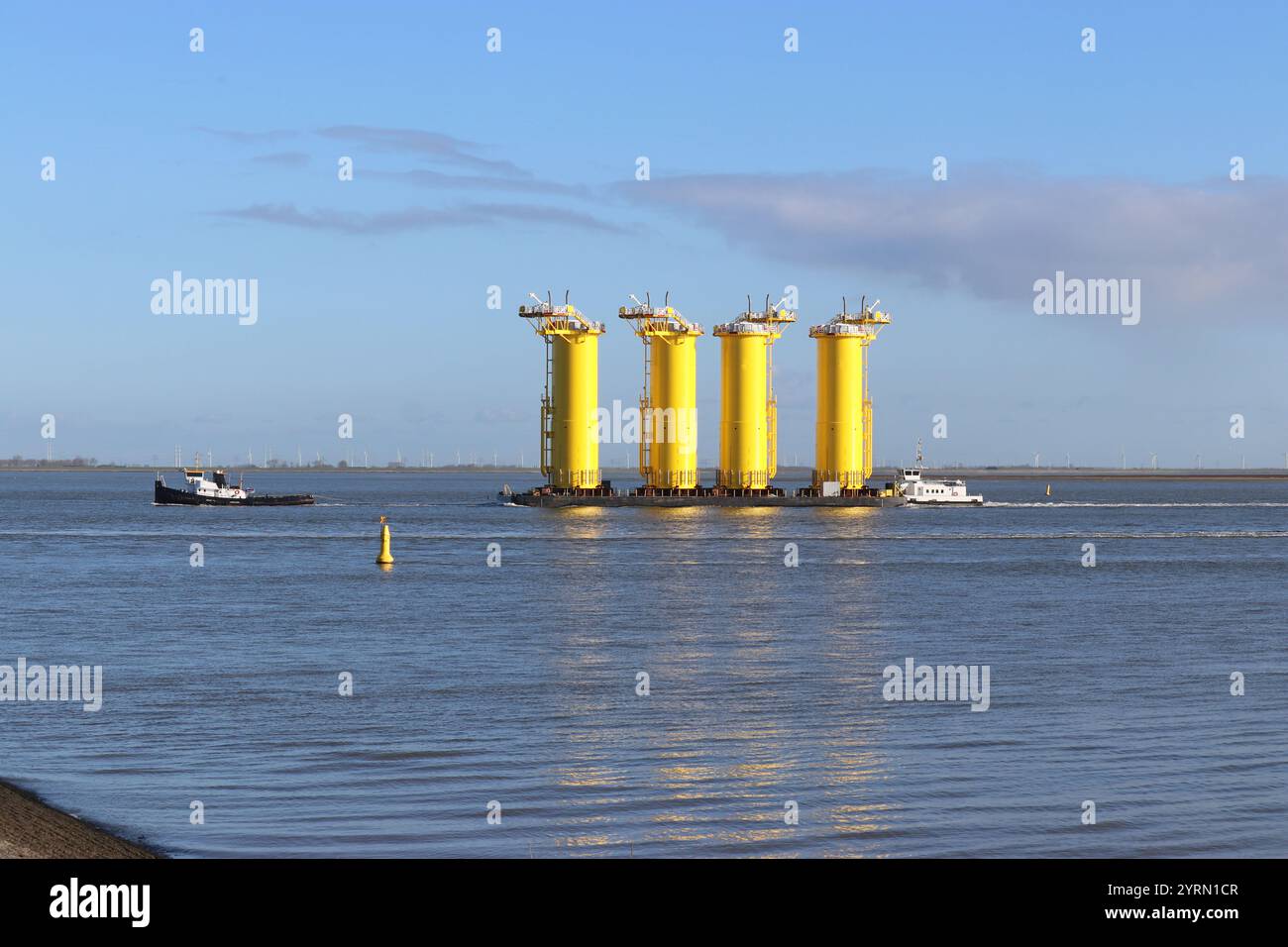 a ship is transporting four tanks over the water of the sea with a ...