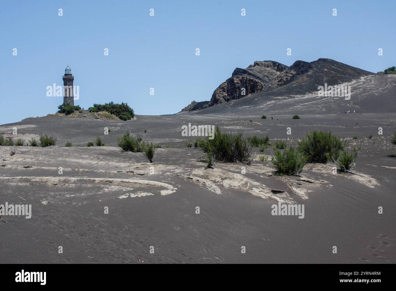 Old Lighthouse stands in new ground of volcanic ash and Rugged Rocky ...
