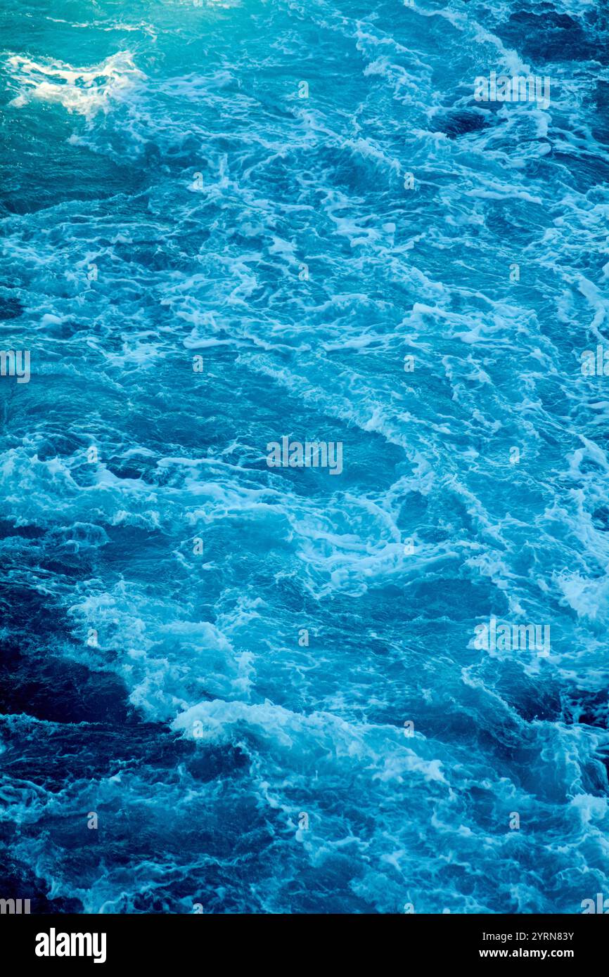 A section of the ocean with churning, turbulent waves. The deep blue ...