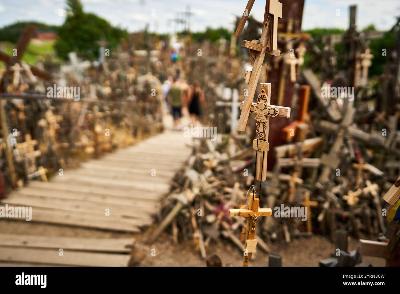 A close-up view of a large wooden cross adorned with smaller crosses ...