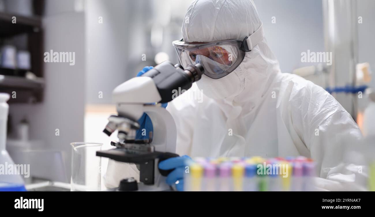 A man in looks through an X-ray microscope Stock Photo - Alamy