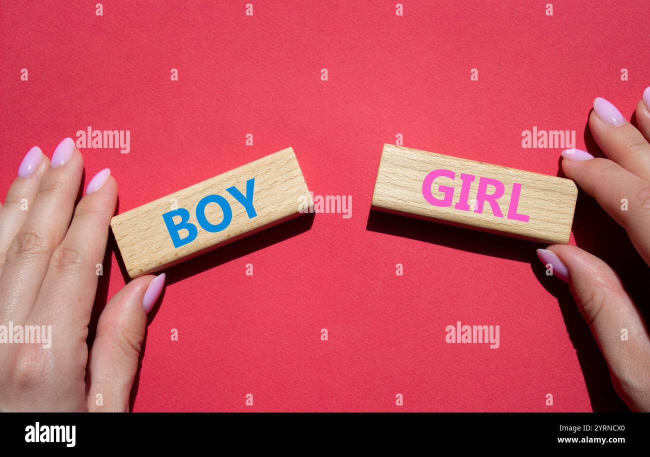 Boy or Girl symbol. Concept word Boy or Girl on wooden blocks. Man hand ...