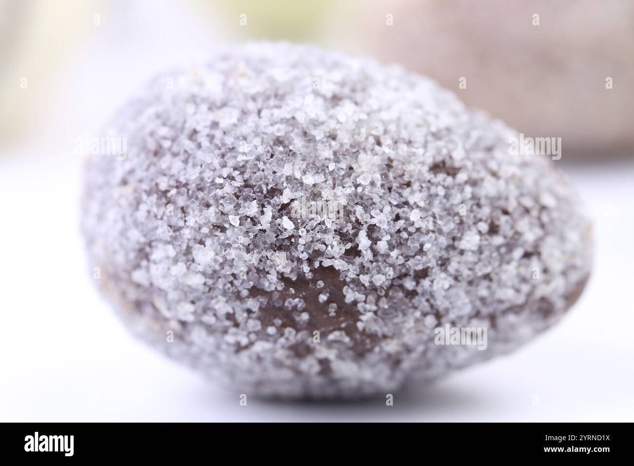 Chocolate stone powdered sugar. Close up. White background Stock Photo ...