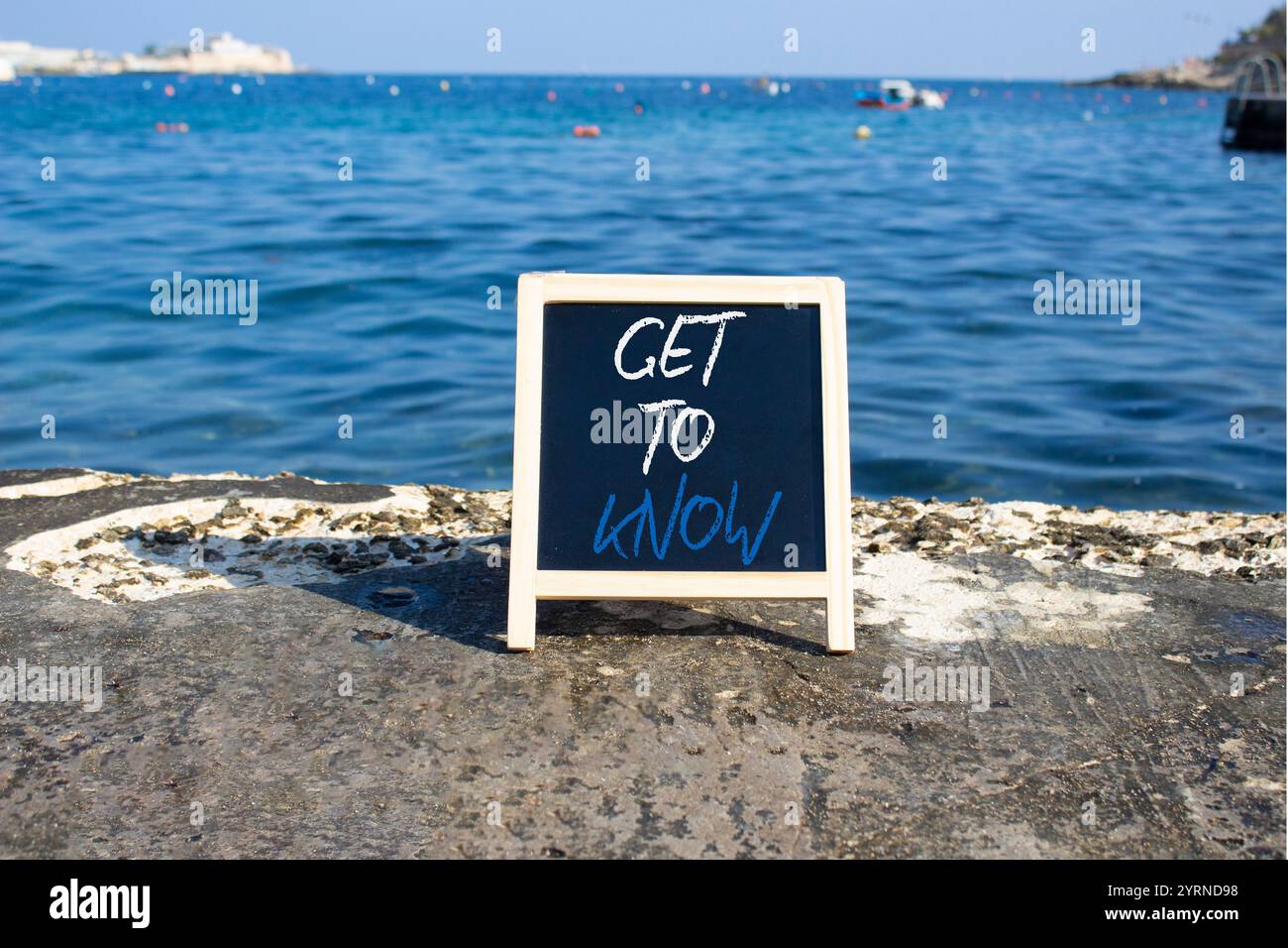 Get to Know symbol. Blackboard with words Get to Know. Beautiful sea ...