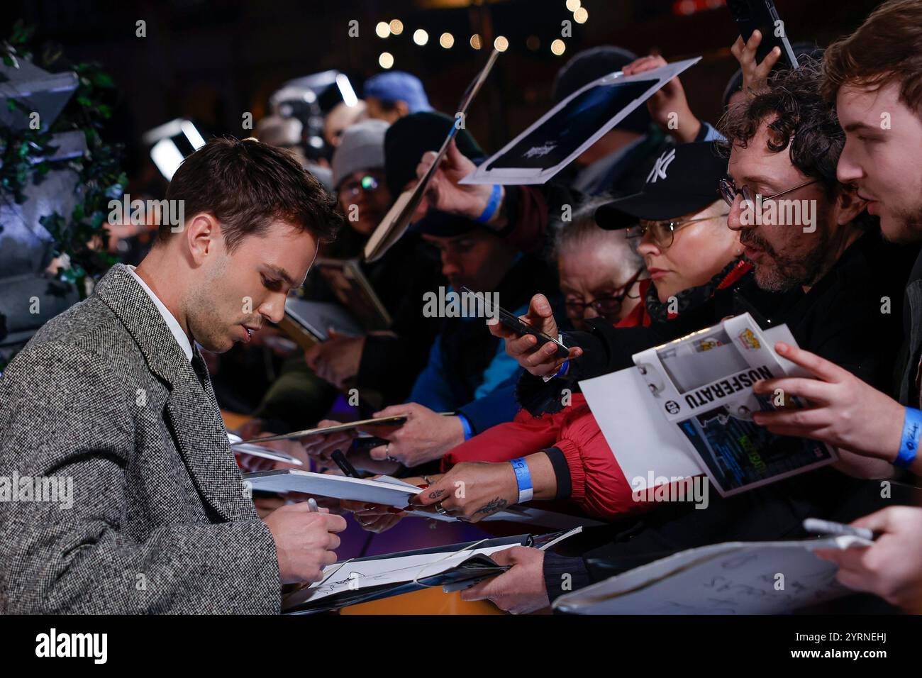 Nicholas Hoult signs autographs upon arrival at the premiere of the ...