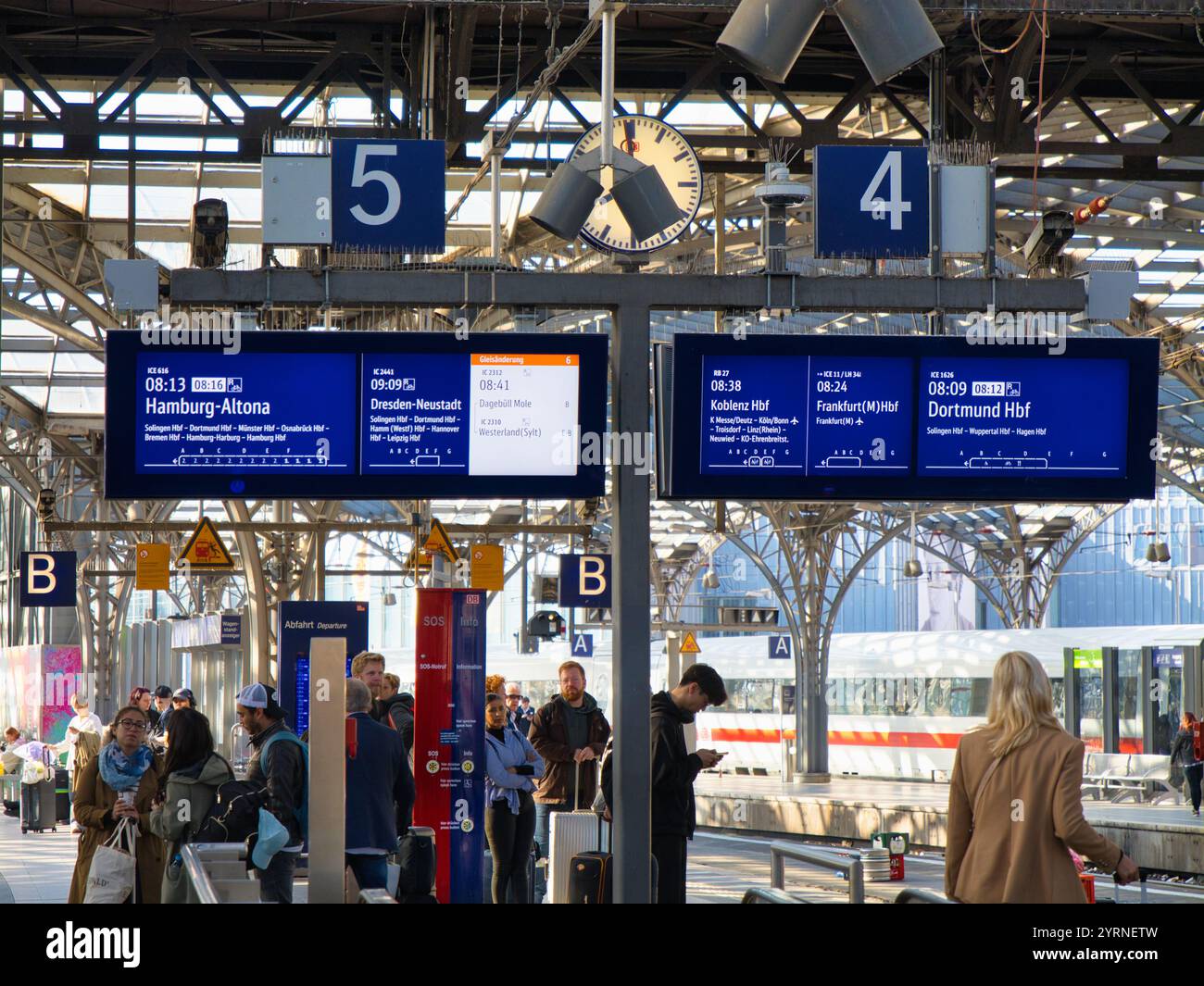 Cologne, Germany - Jun 9 2024: Train information signs above a busy ...