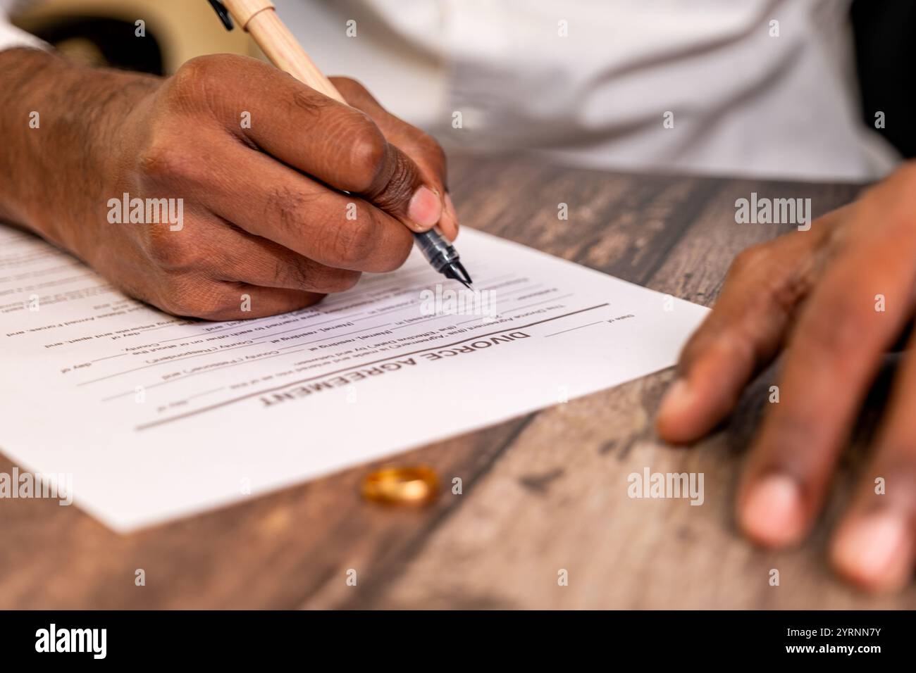 Man signs divorce papers, wedding ring discarded. End of marriage ...