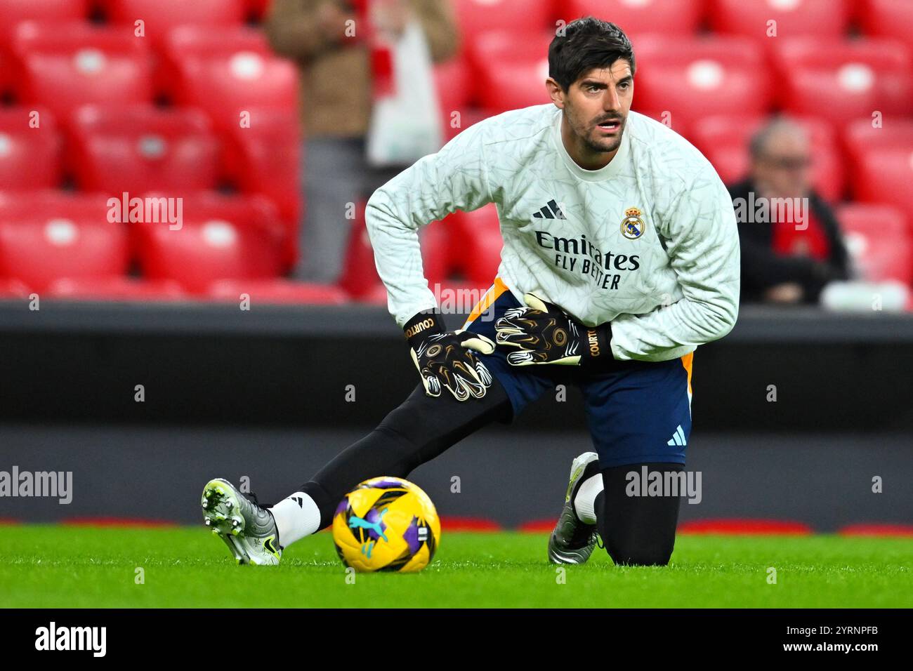 Real Madrid's goalkeeper Thibaut Courtois stretches prior the Spanish ...