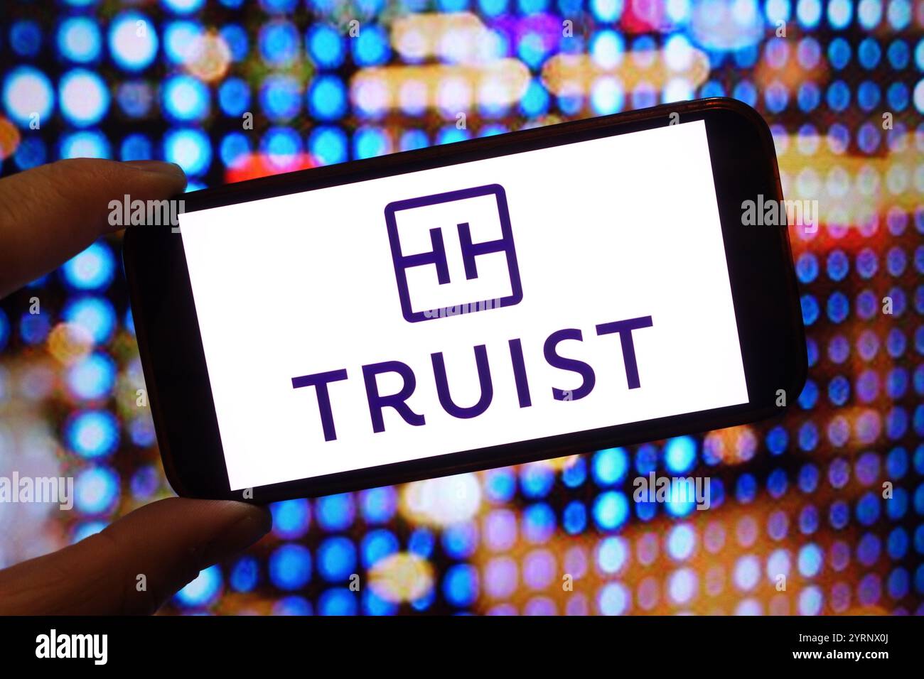 In this photo illustration, the Truist Financial company logo is seen ...