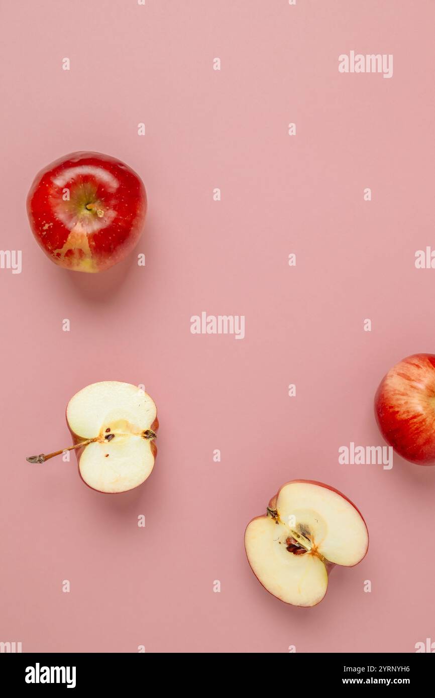Red apple, half apple and quarter apple on pink background. Top view ...