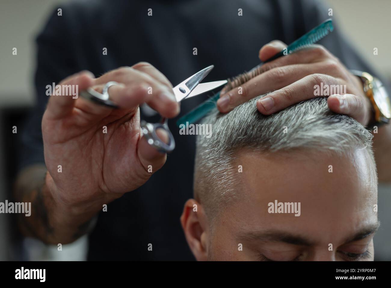 Professional man cutting hair with scissors and comb of man with short ...