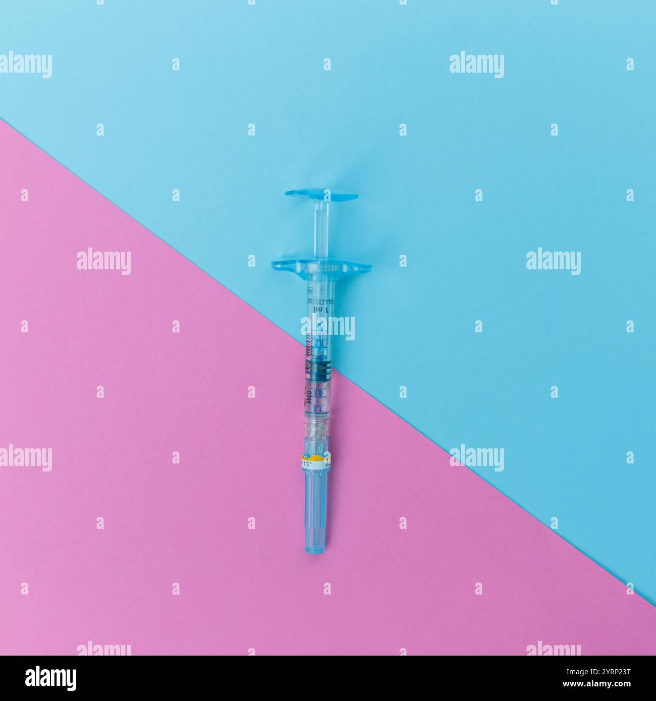 Filler injection for lip augmentation lies on blue pink background ...