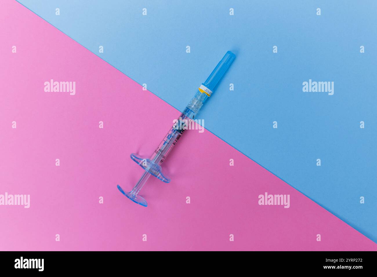 Filler injection for lip augmentation lies on blue pink background ...