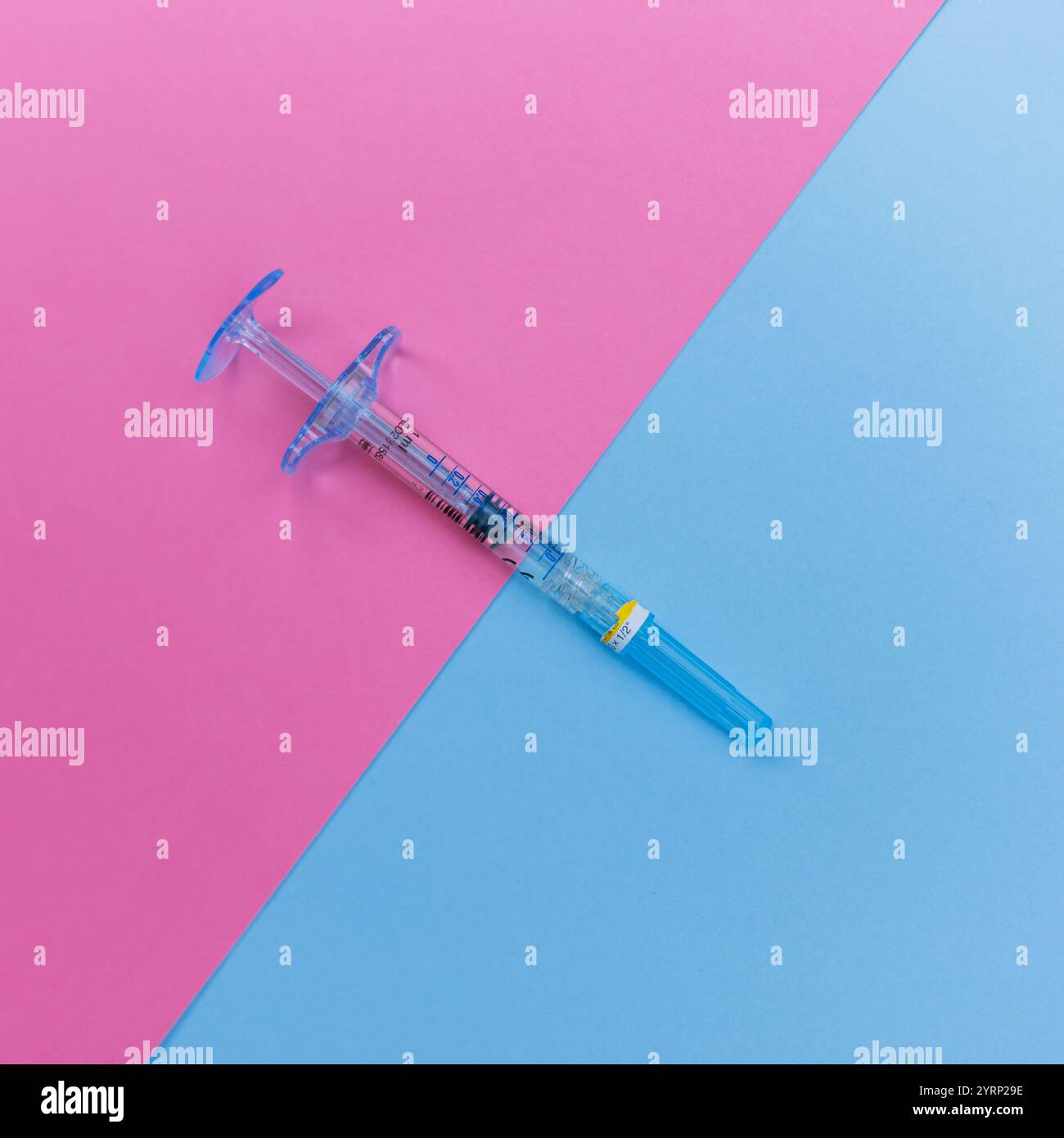 Filler injection for lip augmentation lies on blue pink background ...