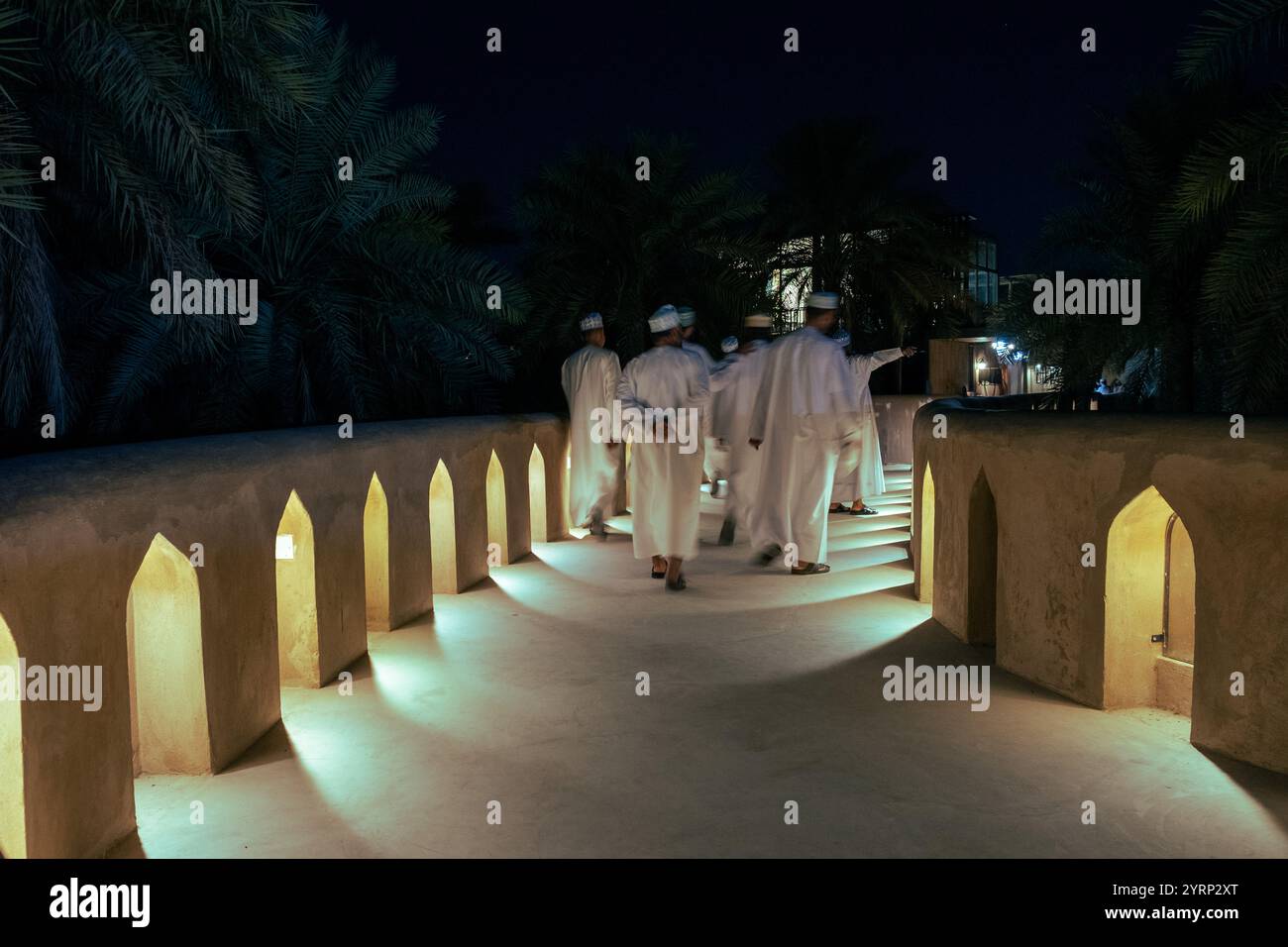 Group of muslim gents with traditional white Thawb strolling on the ...