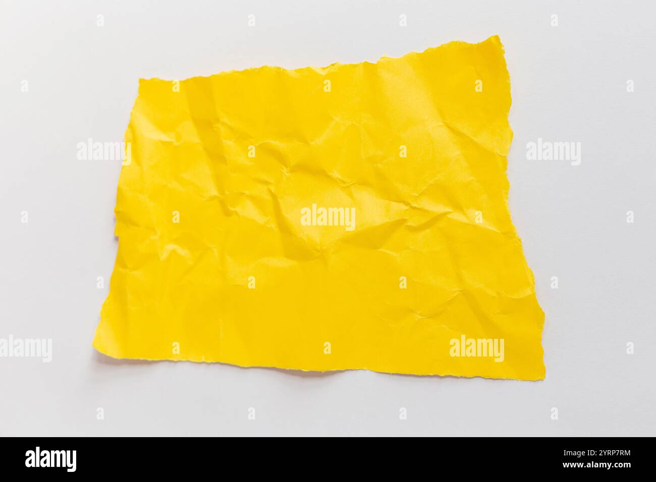 Yellow torn crumpled paper lies on a white background. Text note. Free ...