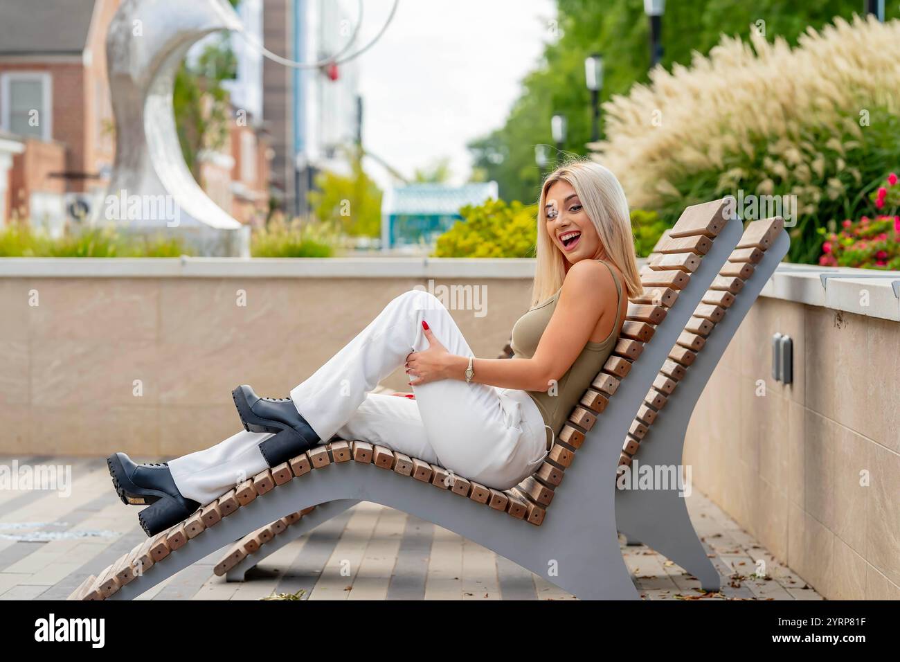 A beautiful young woman strolls through her quaint small town, basking ...