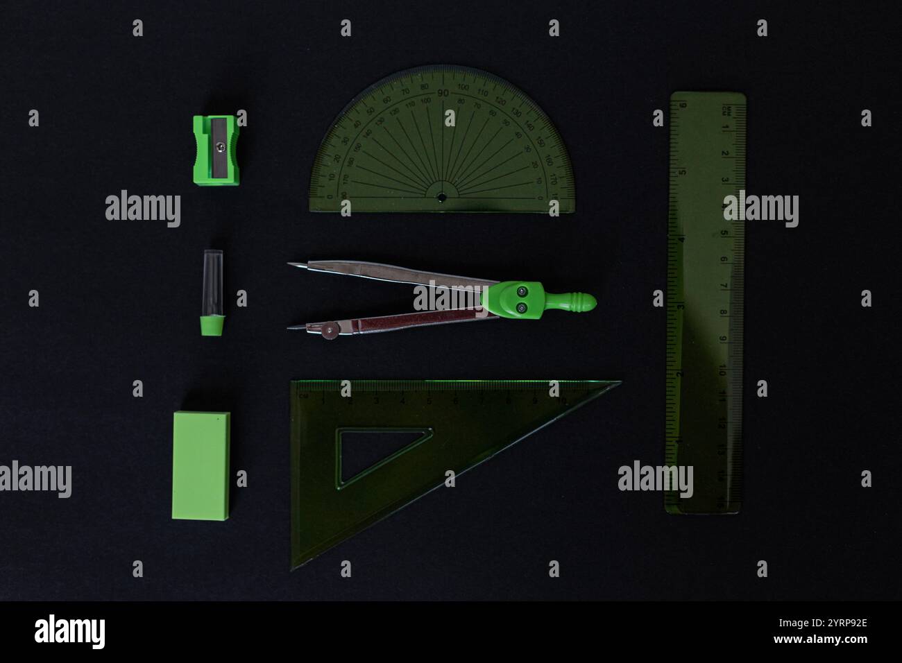 green set of geometry tools with compass, rulers, eraser and sharpener ...