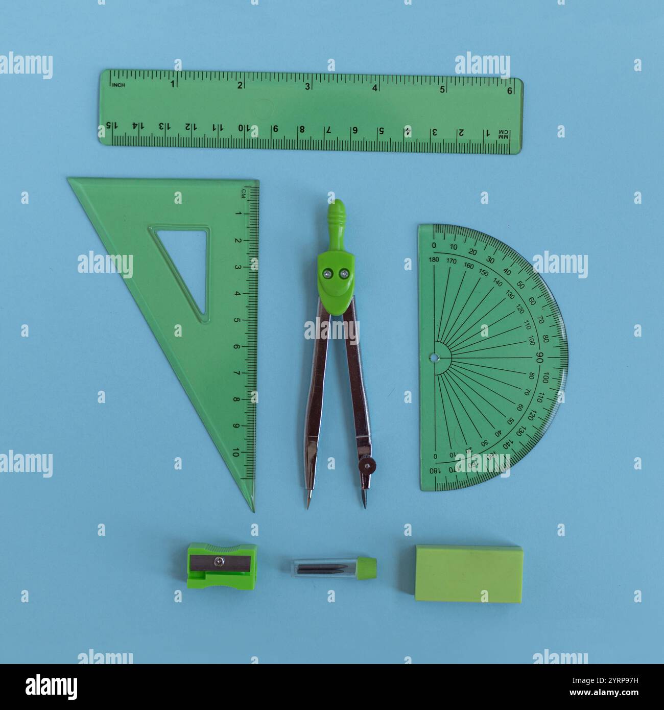 green set of geometry tools with compass, rulers, eraser and sharpener ...