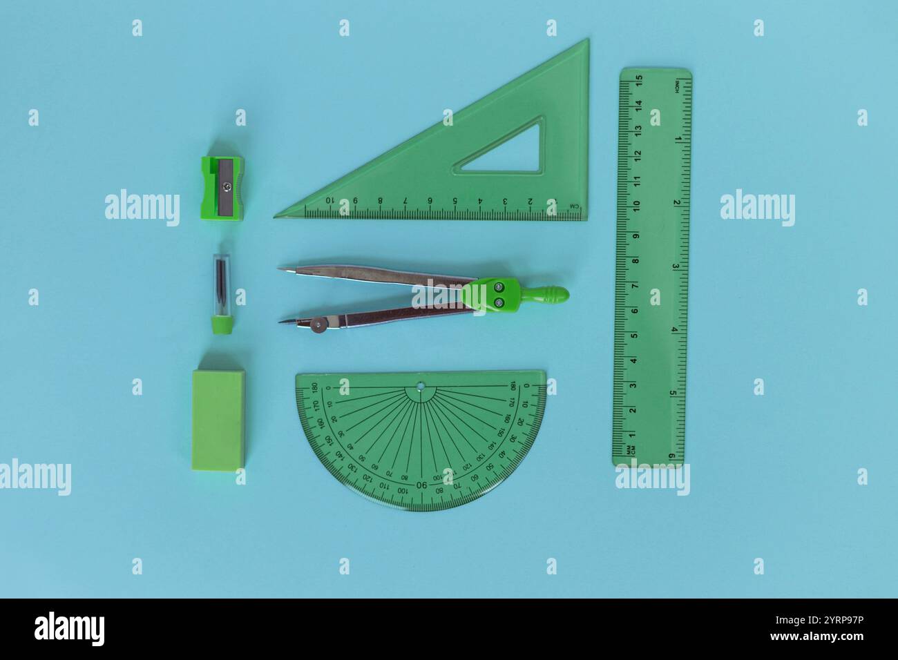 set of green geometry tools: rulers, compasses, eraser and sharpener ...