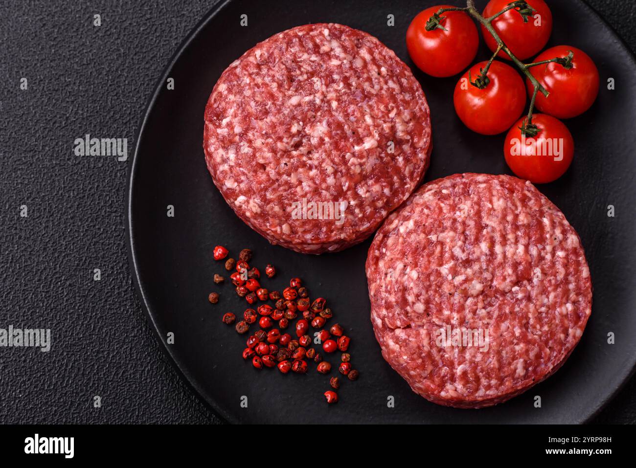 Fresh raw ground beef burger patty with salt and spices on textured ...