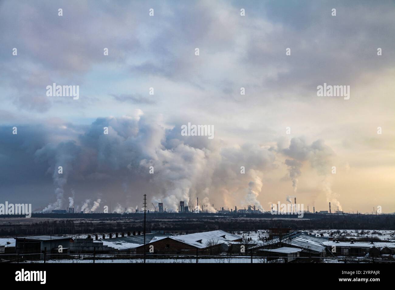 a huge metallurgical plant with many smokestacks on the horizon is ...