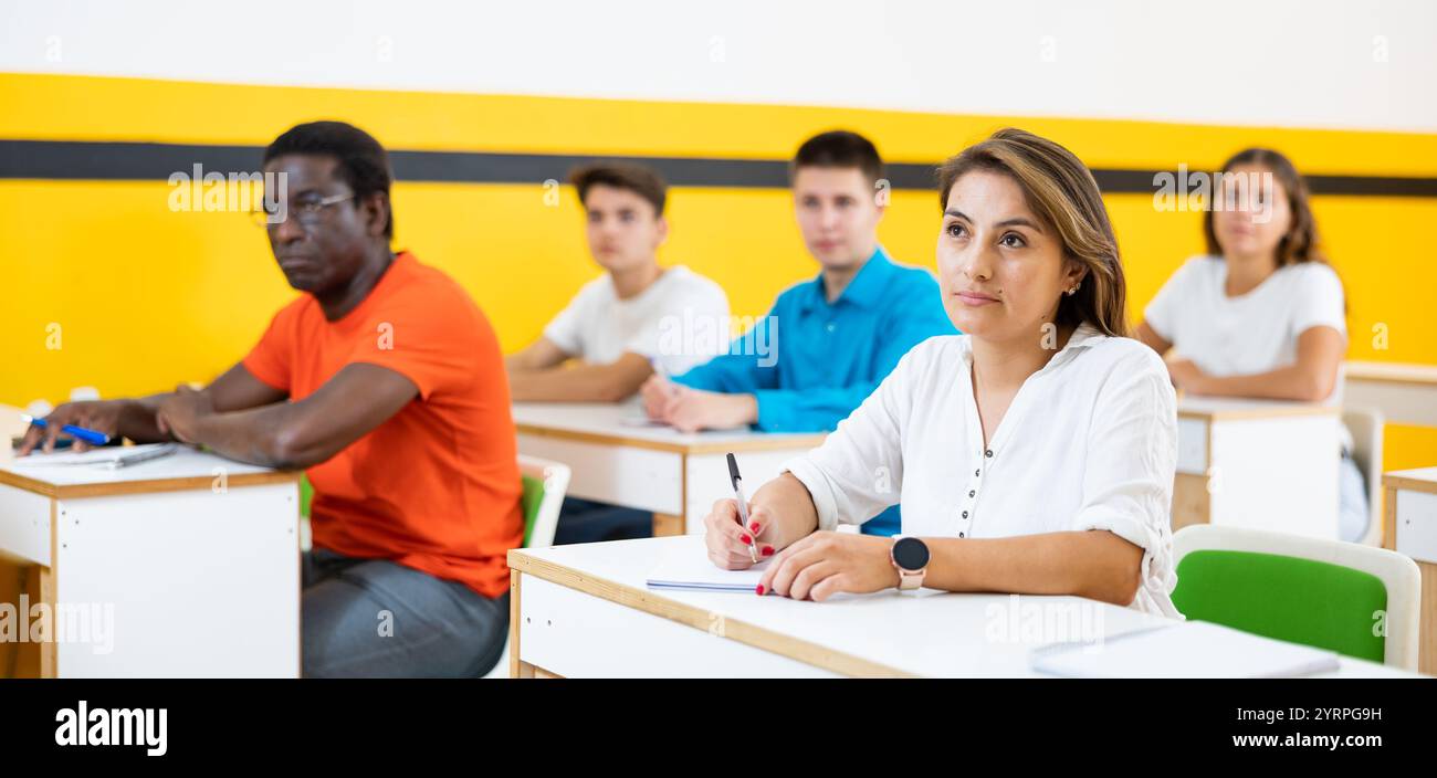 Woman attending lecture in taxi training school Stock Photo - Alamy