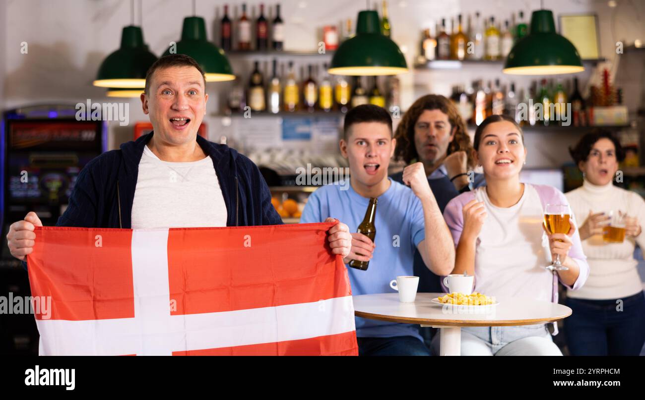 Screaming young adult sports fans rooting for favorite team and waving ...