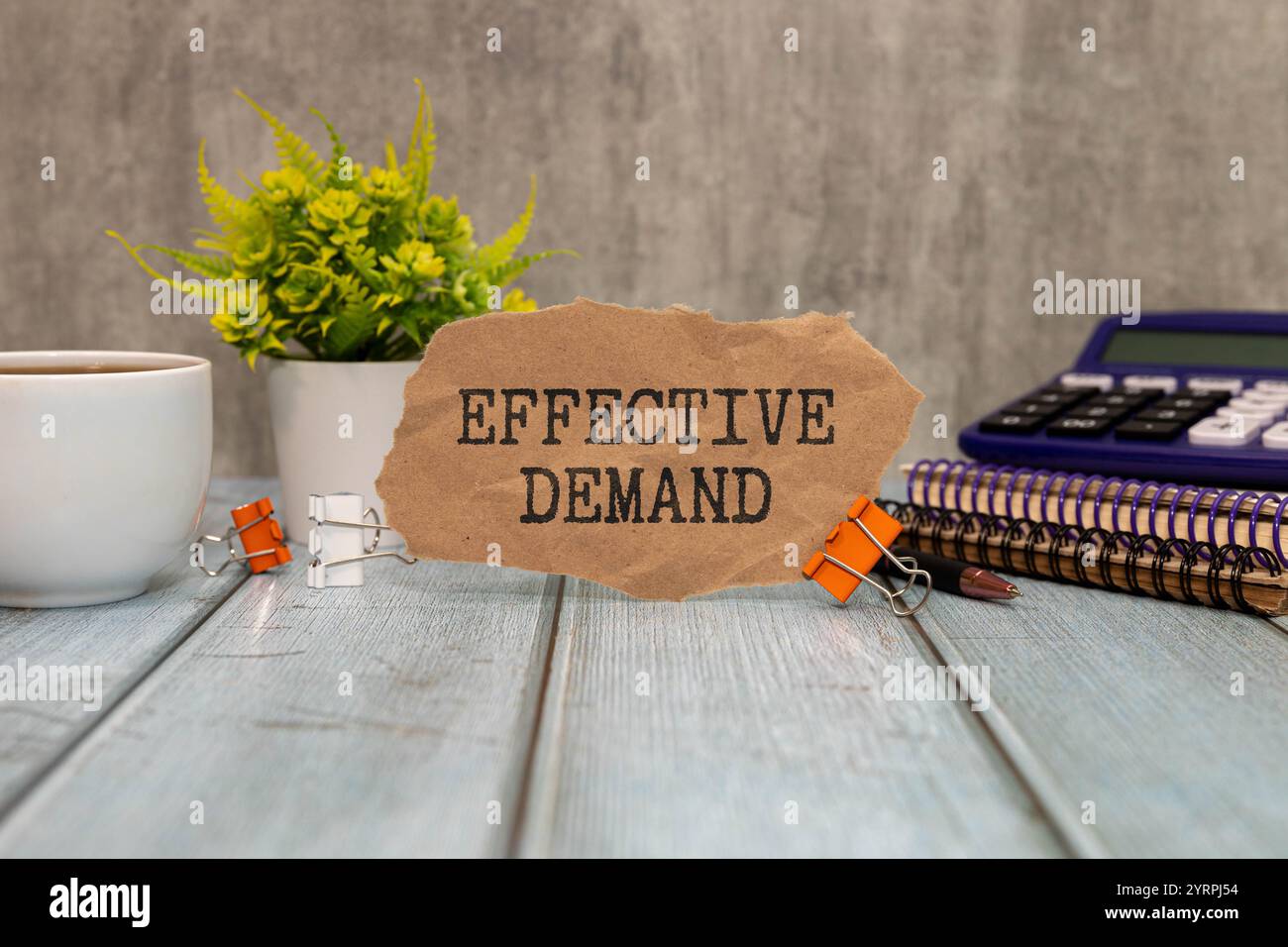EFFECTIVE DEMAND text on notebook with chart and calculator and coins ...