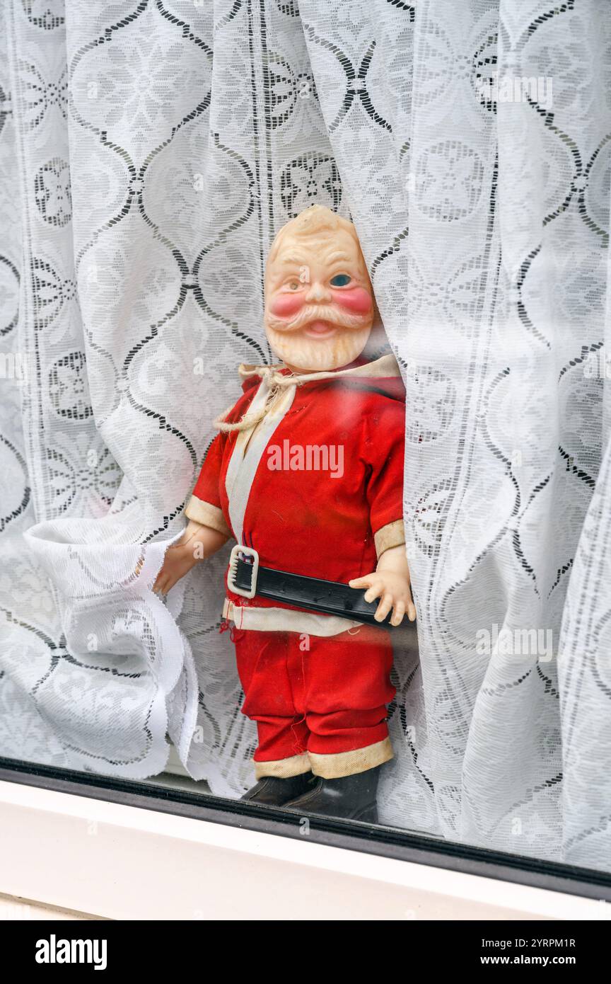 A model of a creepy Santa Claus in a house window Stock Photo - Alamy